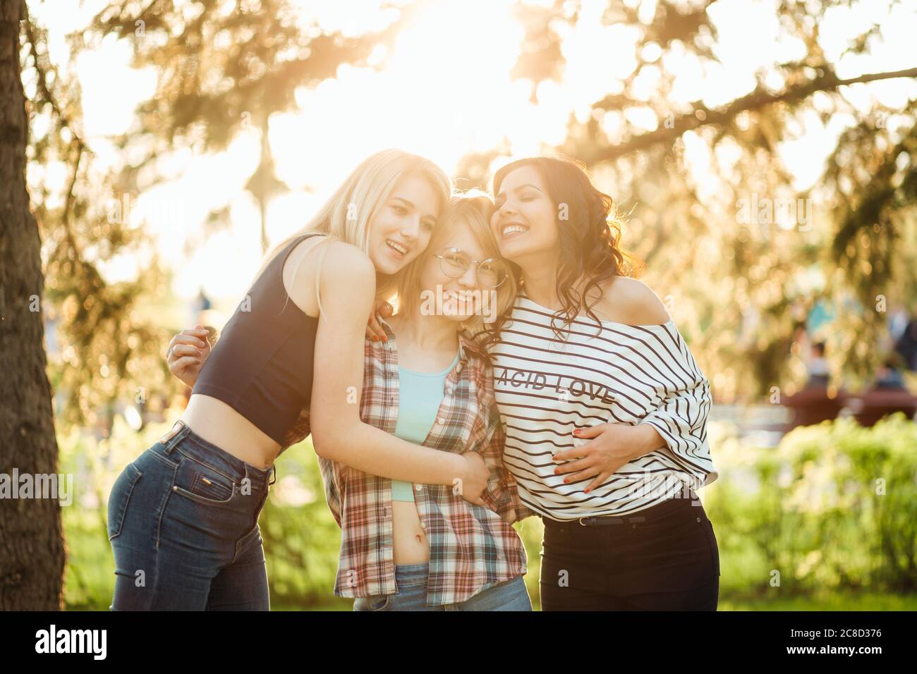 Happy meeting of two friends hugging in the street Stock Photo - Alamy