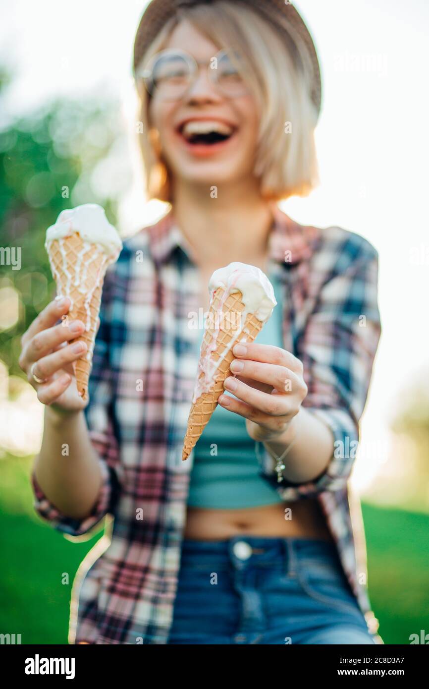 Happy girl eating ice cream and having fun. focus on ice cream Stock ...