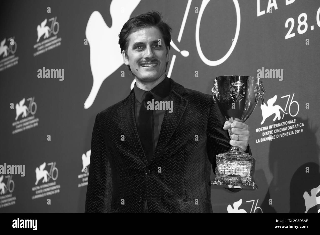 VENICE, ITALY - SEPTEMBER 07: Luca Marinelli poses withthe Coppa Volpi ...