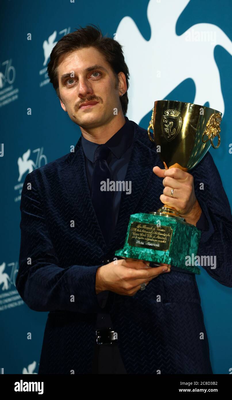 VENICE, ITALY - SEPTEMBER 07: Luca Marinelli poses withthe Coppa Volpi ...