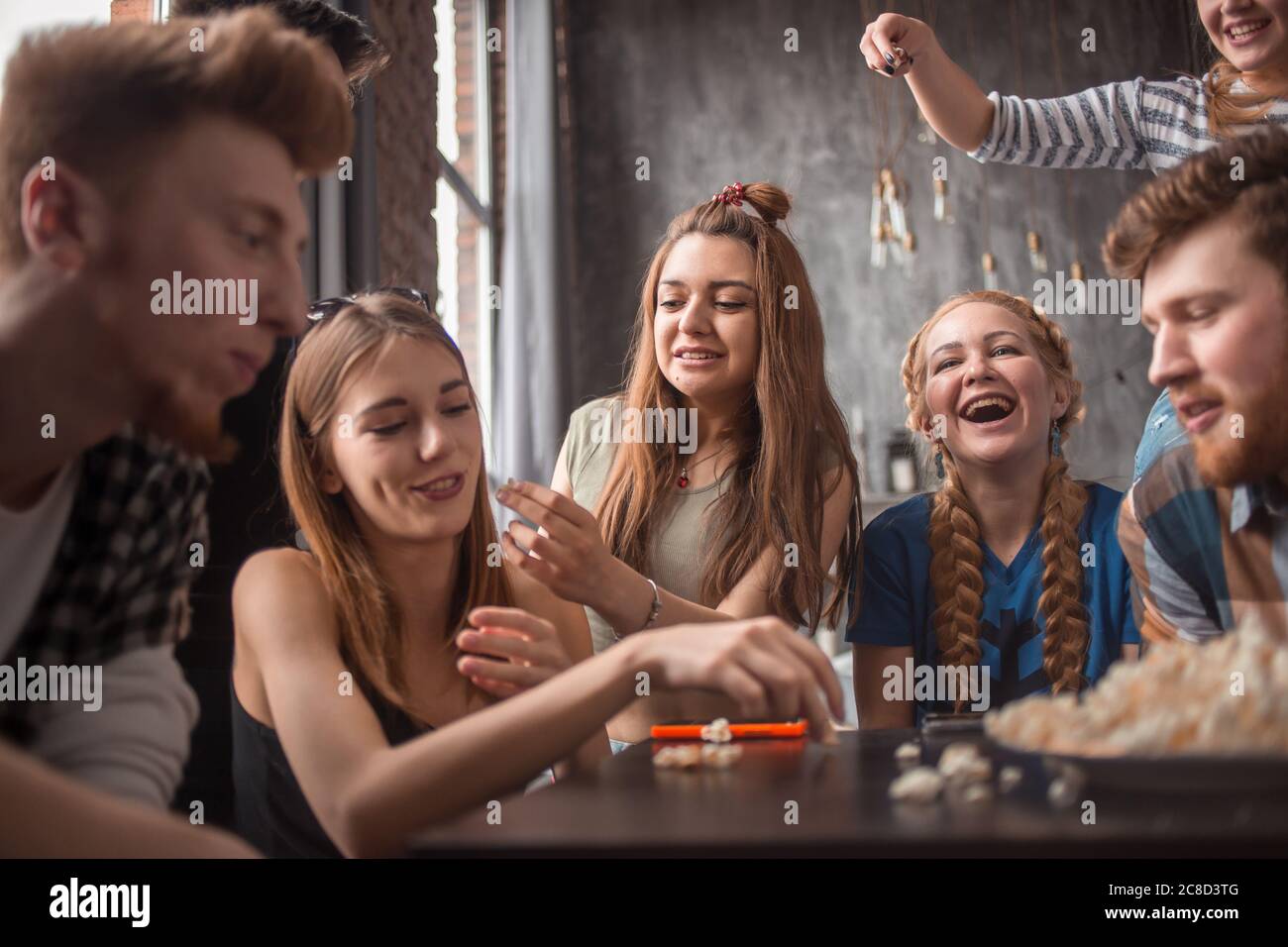Attractive young people throwing popcorn and enjoying together Stock ...