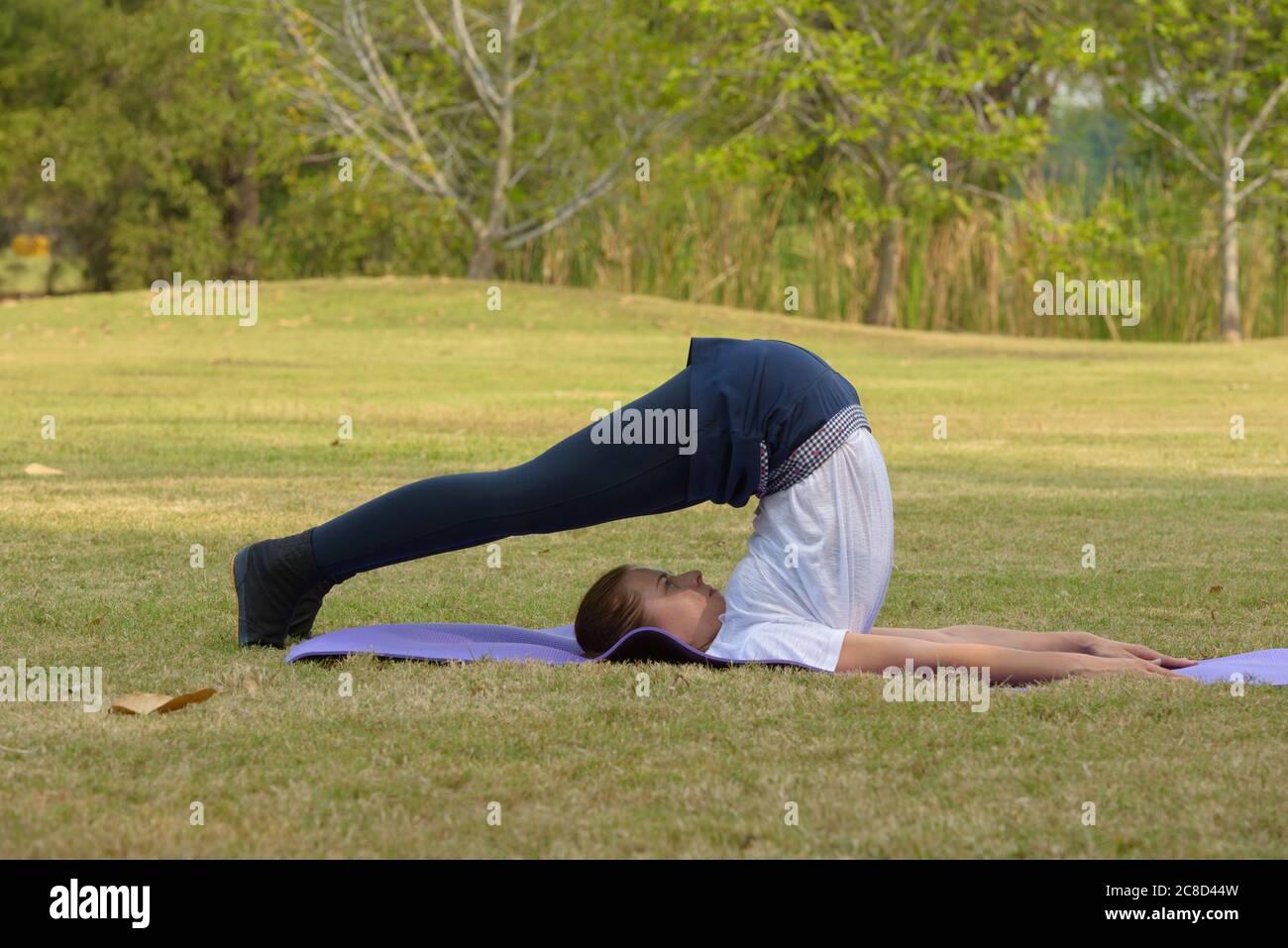 Young beautiful woman exercising at the park outdoors Stock Photo - Alamy