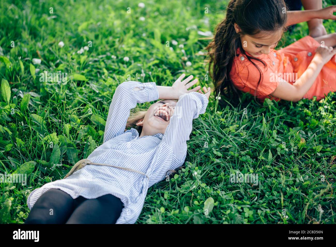Smiling children lying on grass circle hi-res stock photography and ...