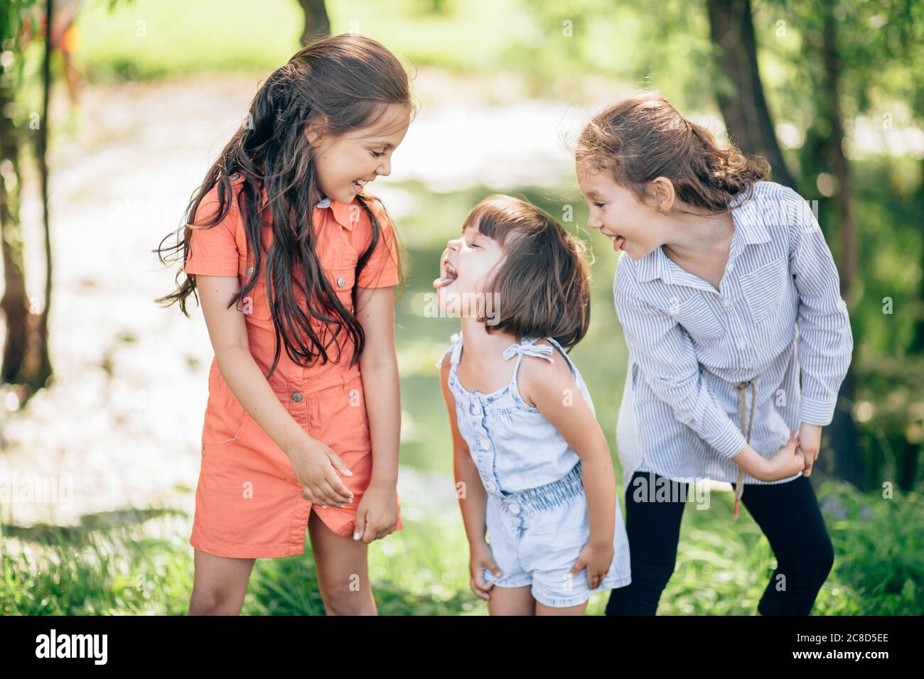 Happy children having fun in spring park Stock Photo - Alamy