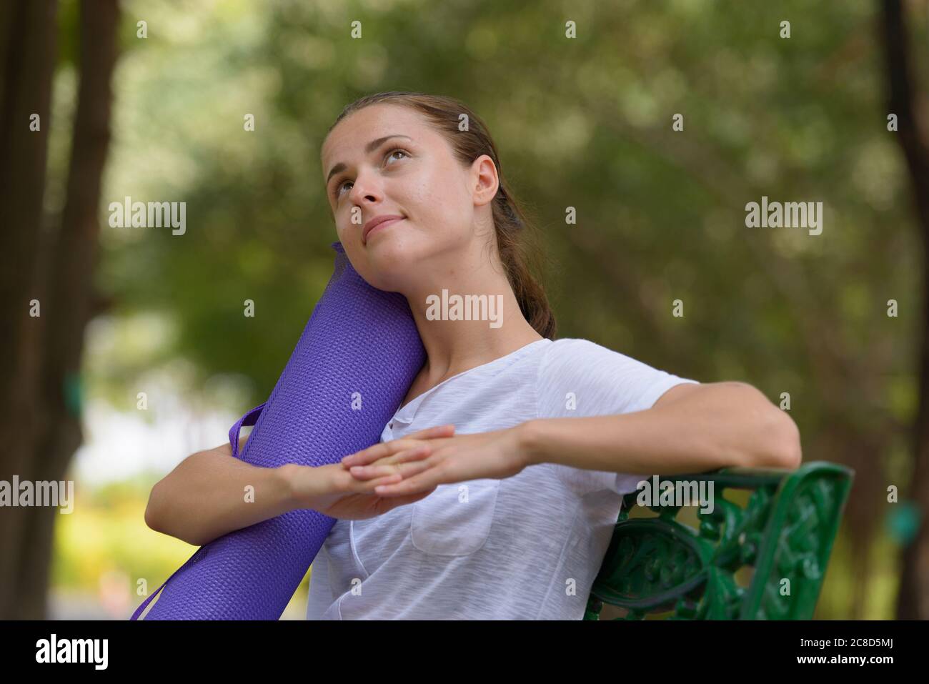 Young beautiful woman exercising at the park outdoors Stock Photo - Alamy