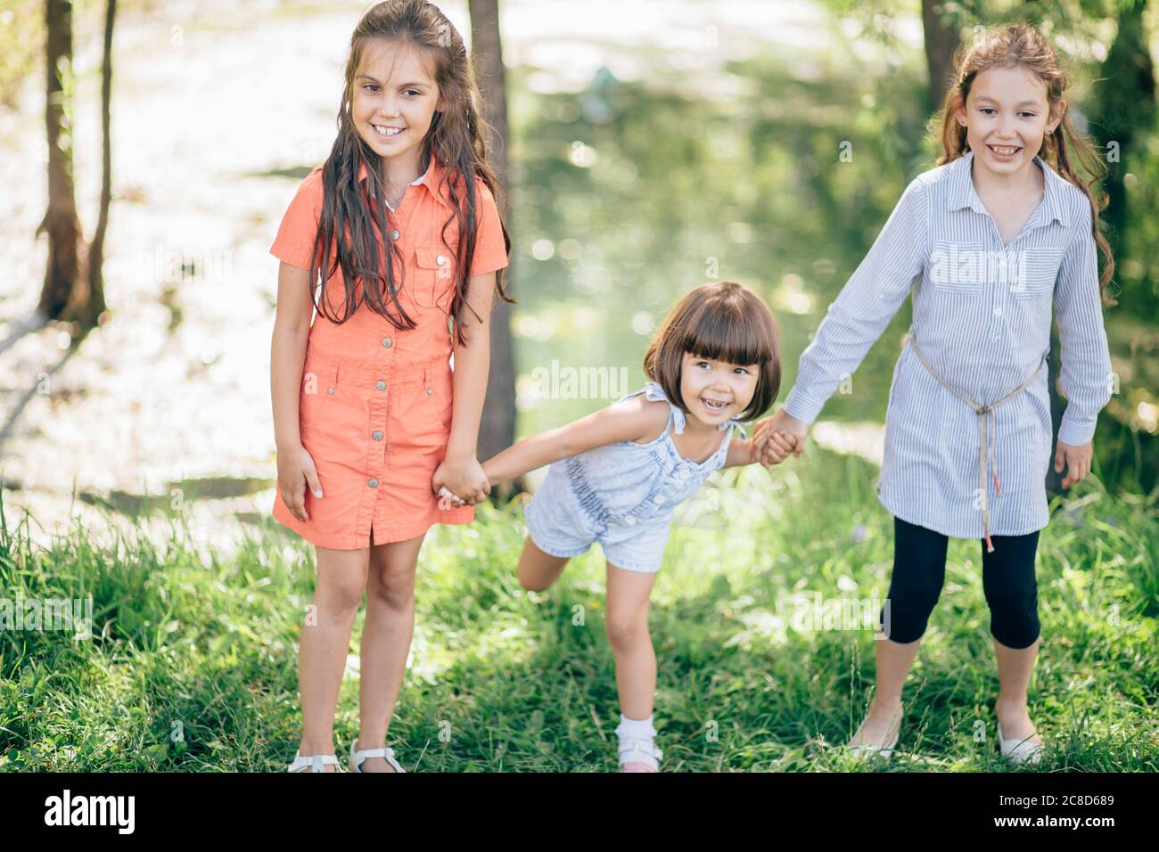 Happy children having fun in spring park Stock Photo - Alamy