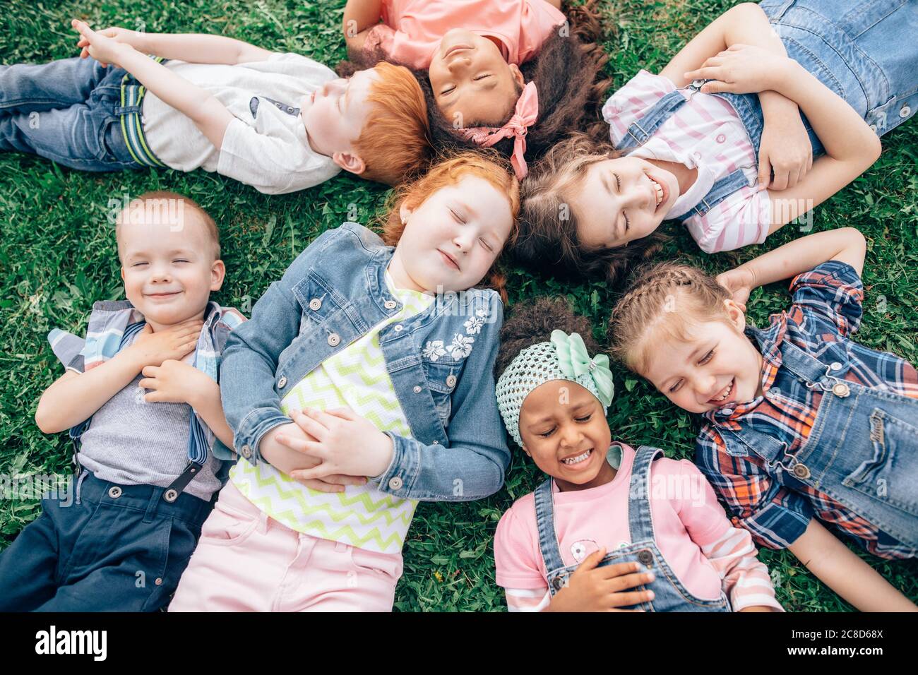 multicultural group of girls on the grass. outdoors. the concept of a ...