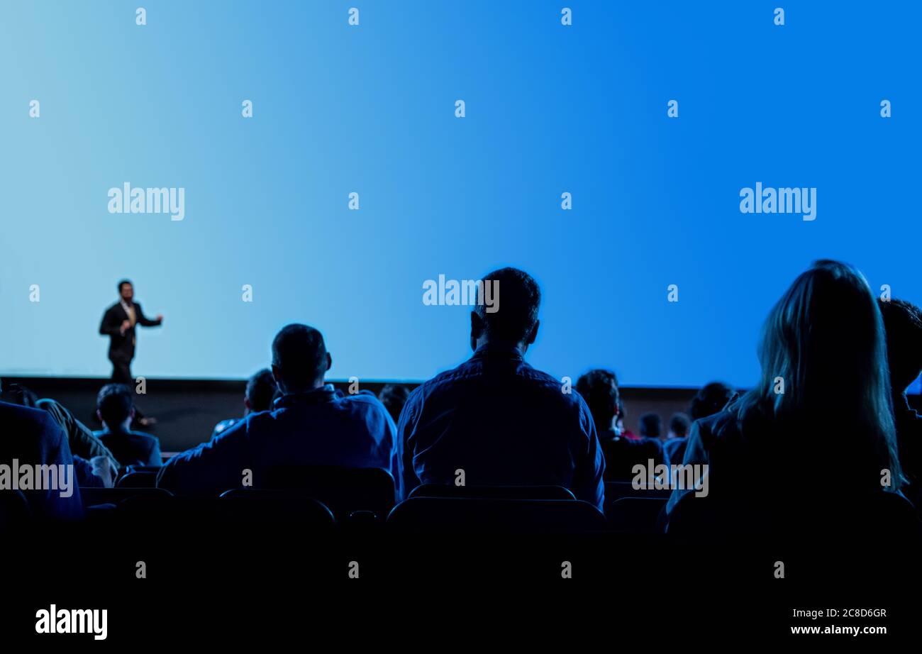 Business or Academic Conference Event. Audience engaged and looking ...