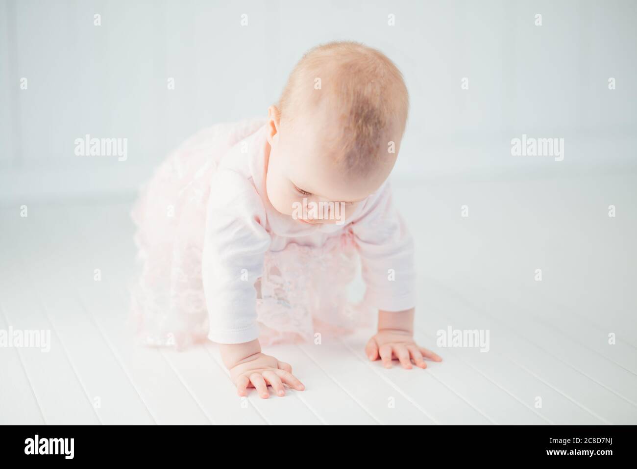 side view of pretty crawling baby on bed Stock Photo - Alamy
