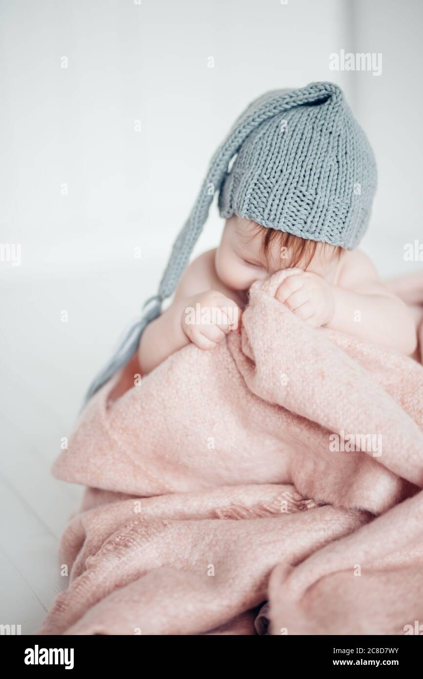 little baby crying on bed over white wall Stock Photo - Alamy