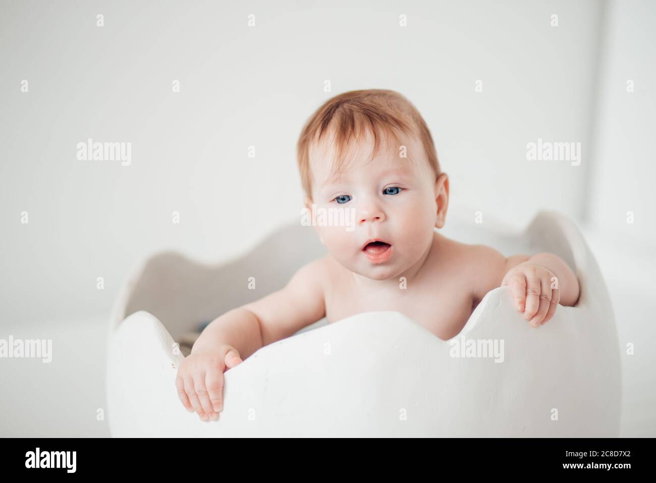 Beautiful little baby inside an white egg Stock Photo - Alamy