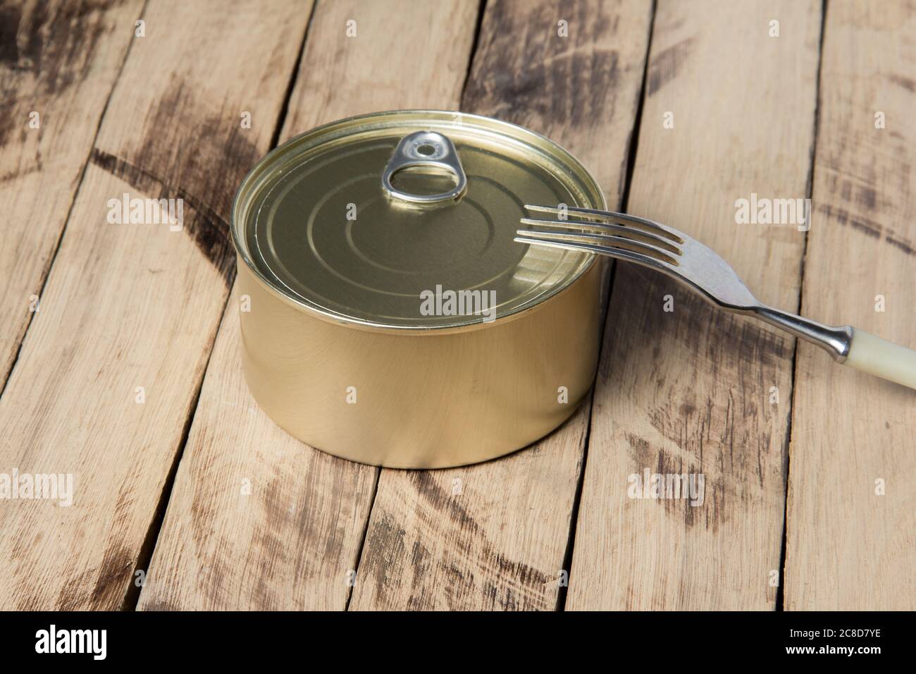 Food Can and Fork on a Wooden Table. Packaging, product. Storage of ...