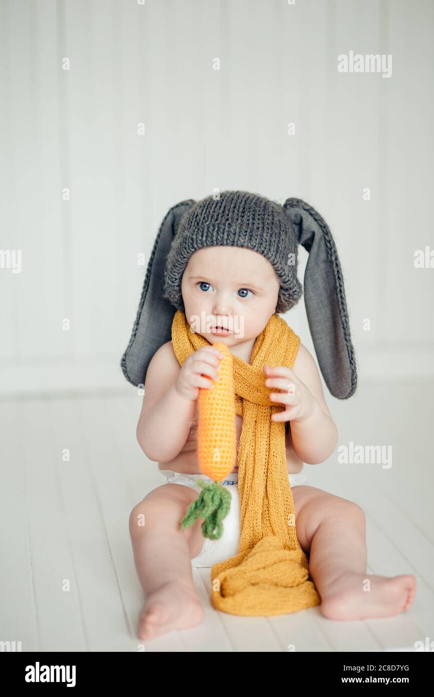 Beautiful cute soft baby sitting on bed Stock Photo - Alamy