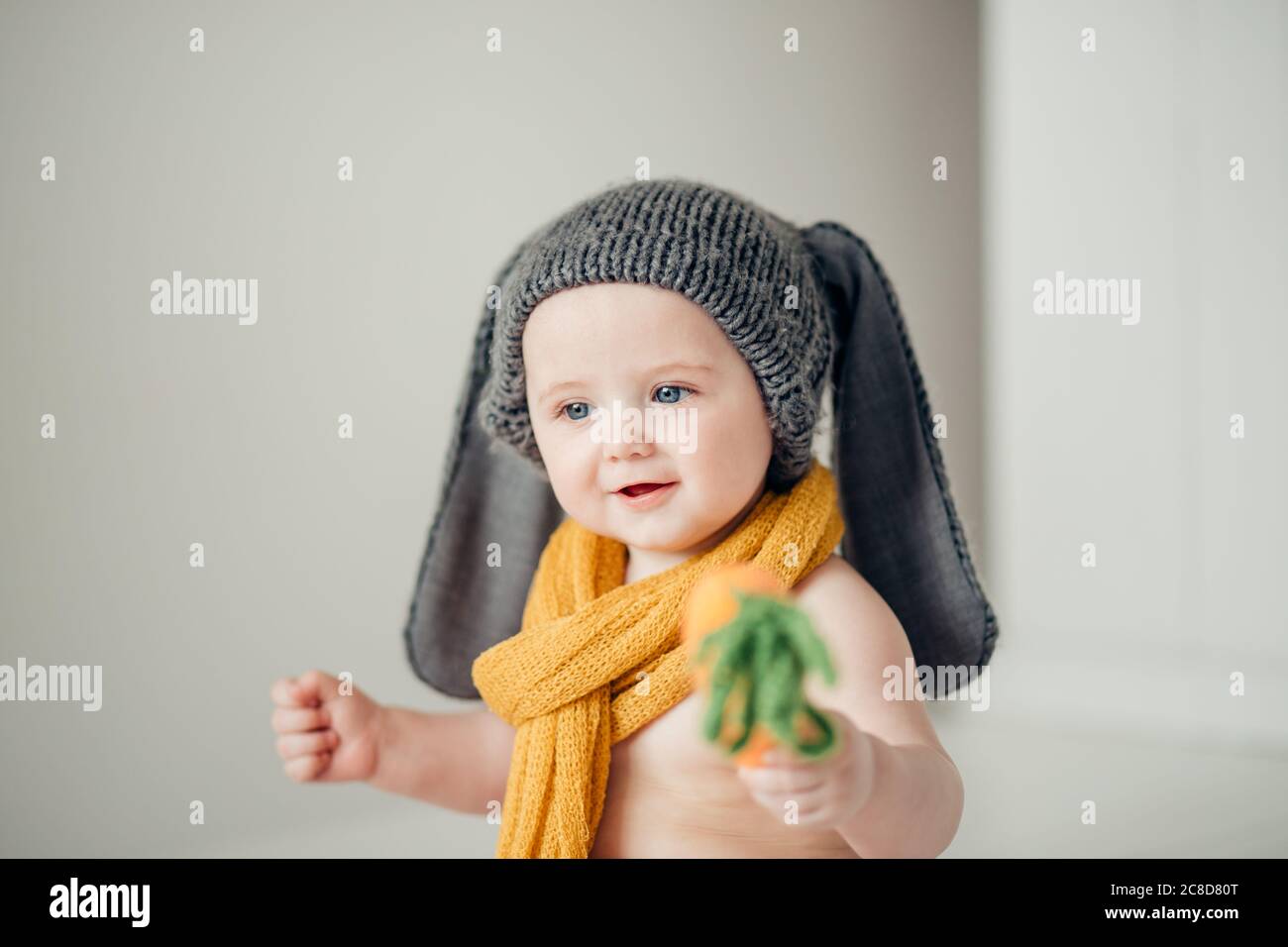 Beautiful cute soft baby sitting on bed Stock Photo - Alamy
