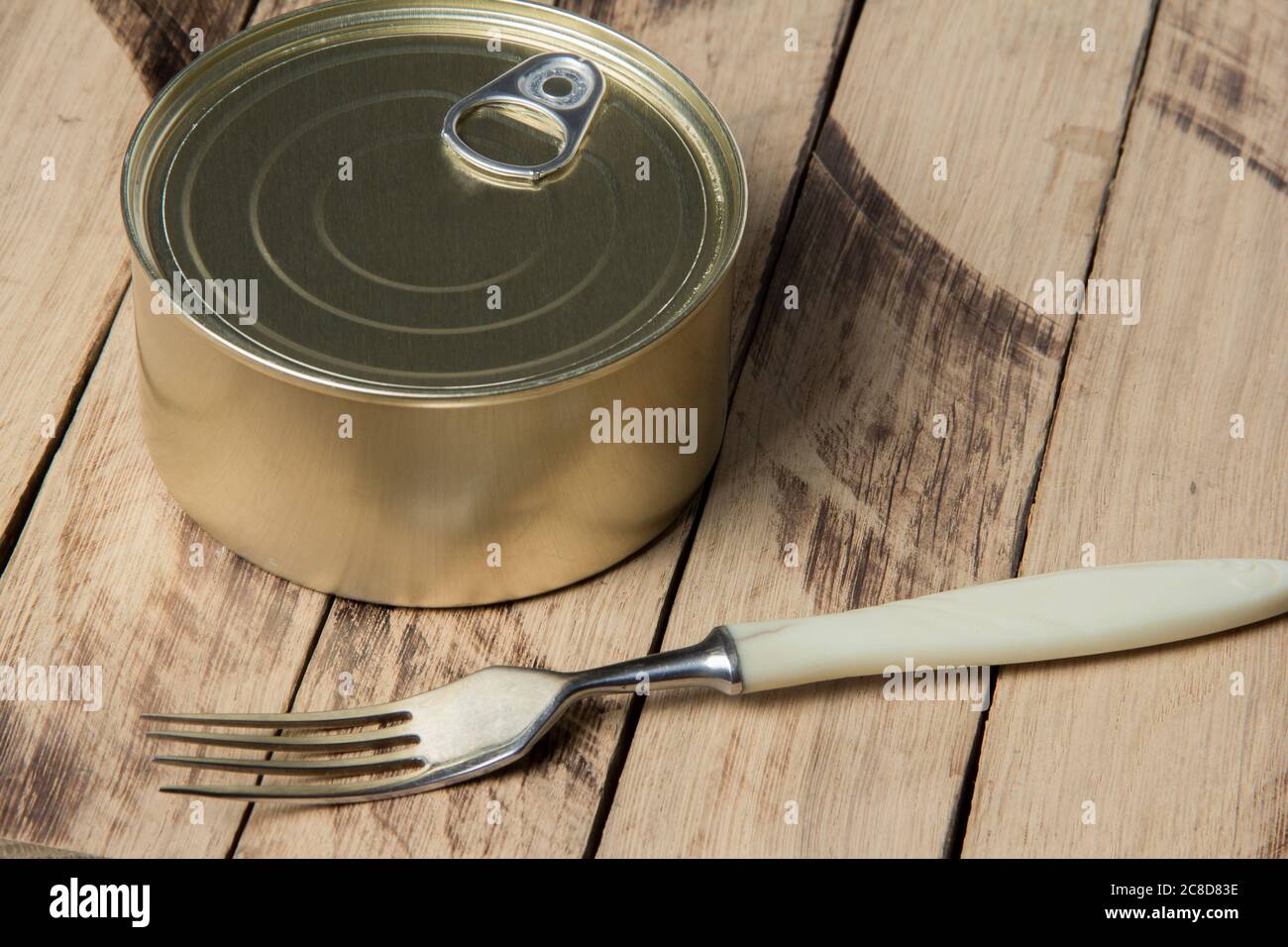 Food Can and Fork on a Wooden Table. Packaging, product. Storage of ...