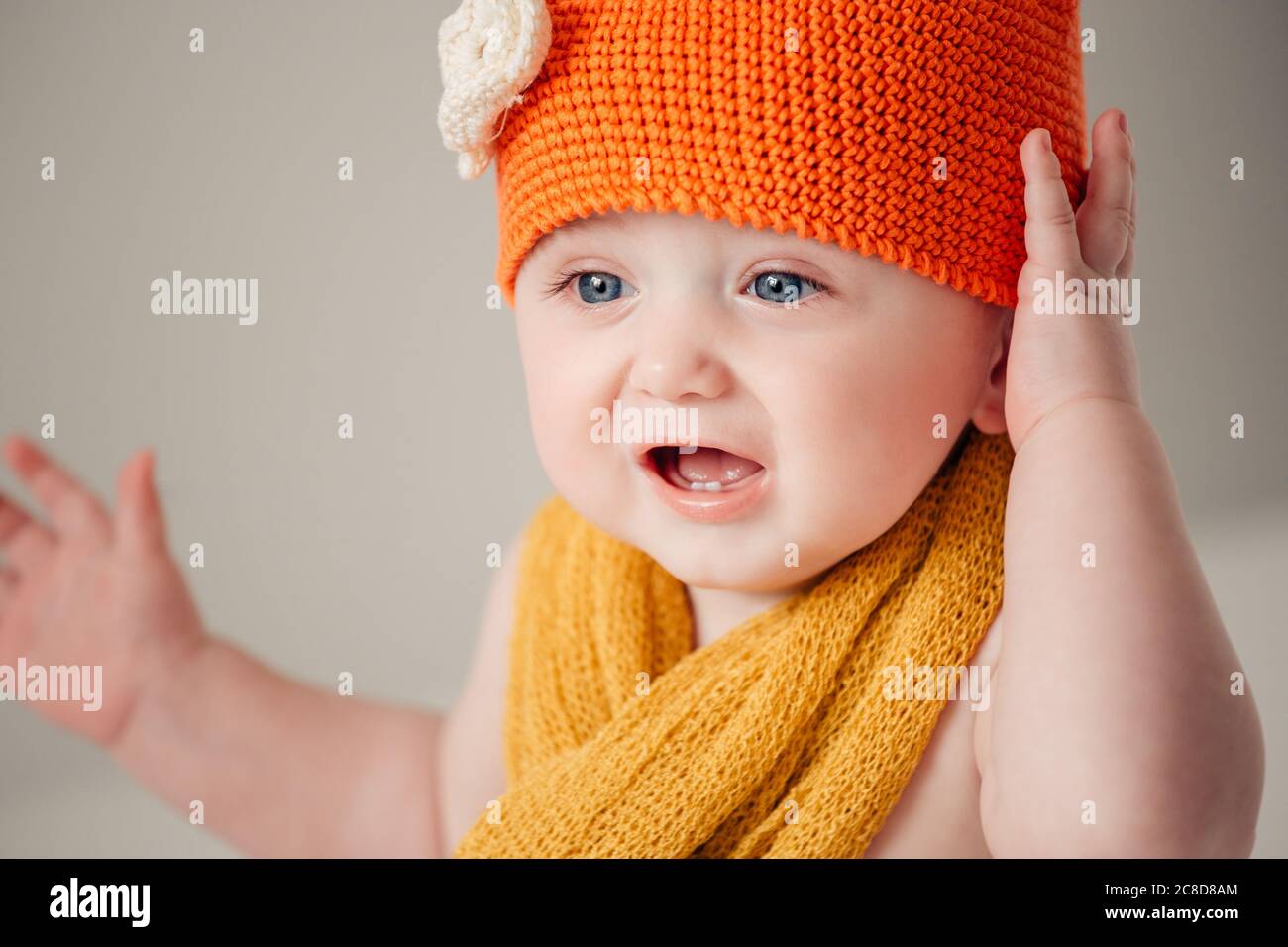 A young baby having a fit on the ground crying and making a pout face ...