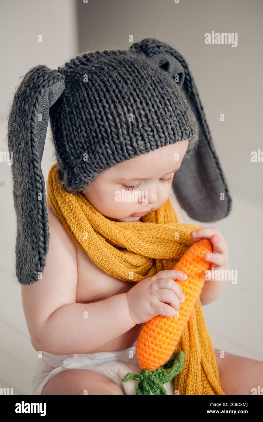 Beautiful cute soft baby sitting on bed Stock Photo - Alamy