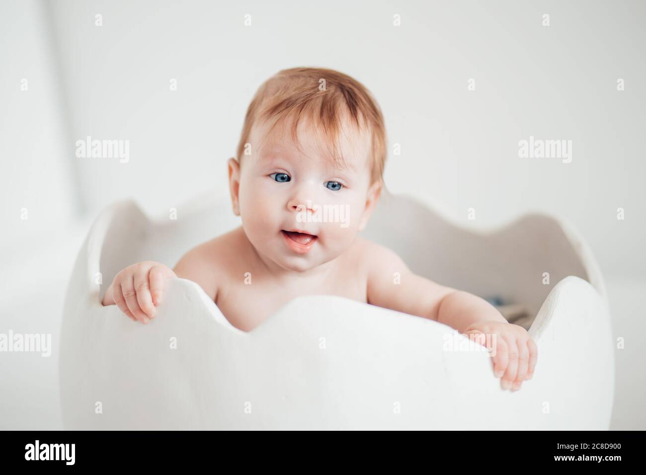 Beautiful little baby inside an white egg Stock Photo - Alamy