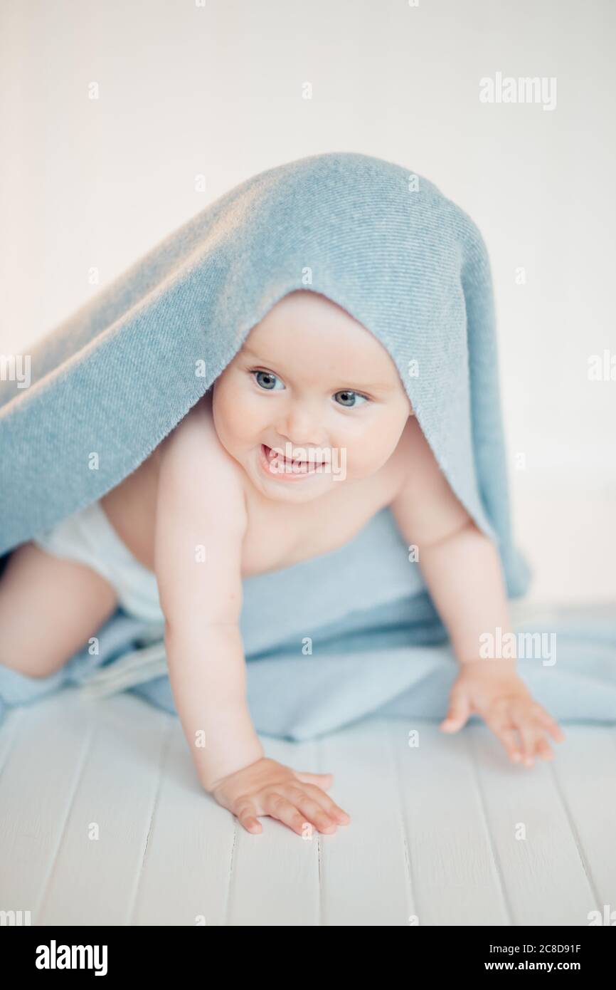 side view of pretty crawling baby on bed Stock Photo - Alamy