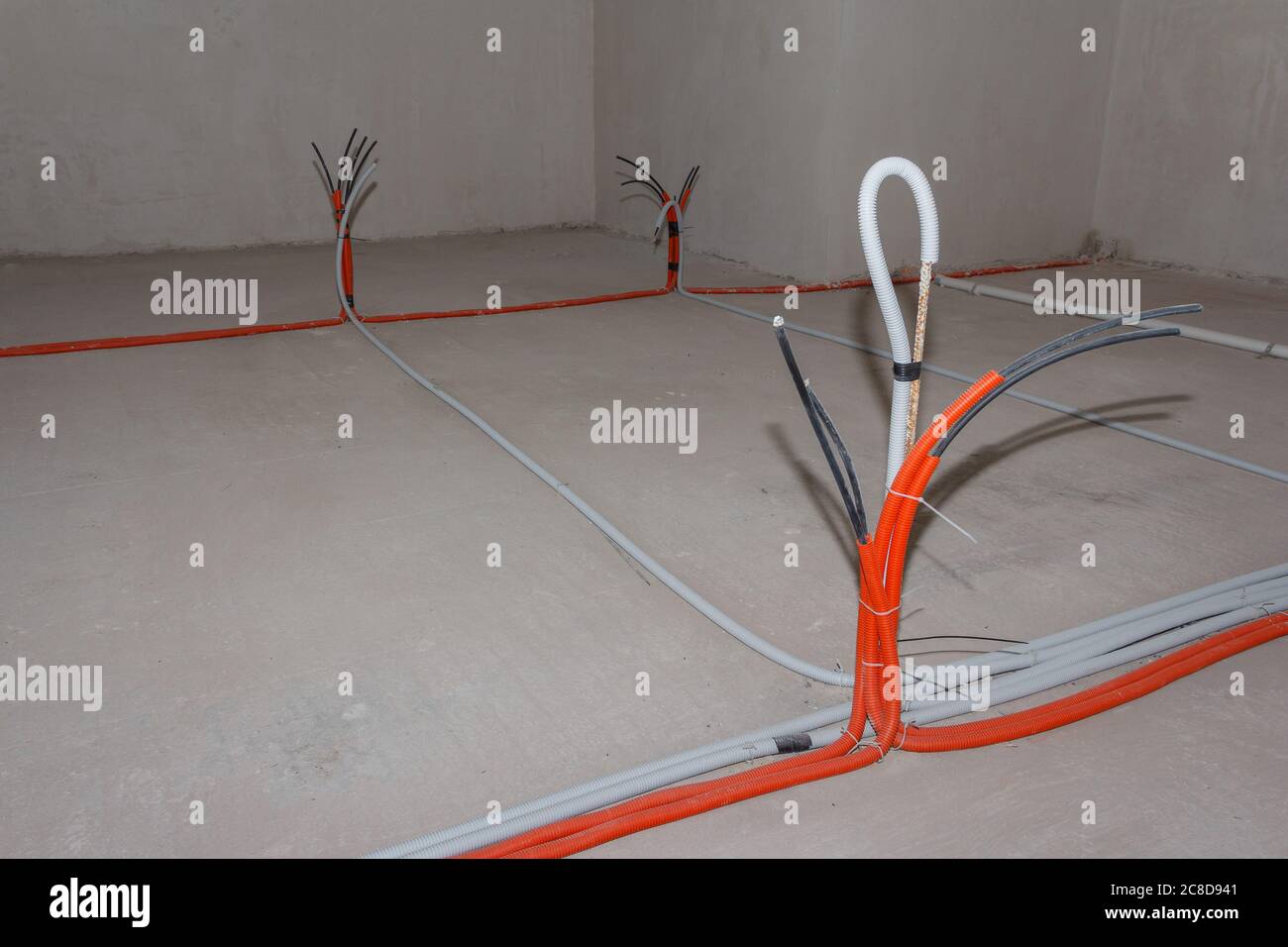 Insulated electric cables are installed on the floor in a building ...