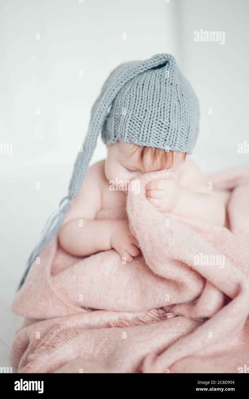 A young baby having a fit on the ground crying and making a pout face ...