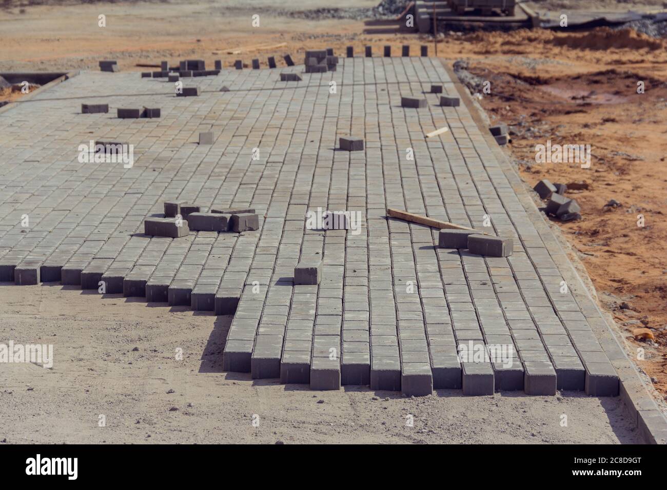 Construction of pavement near the house. Bricklayer places concrete ...