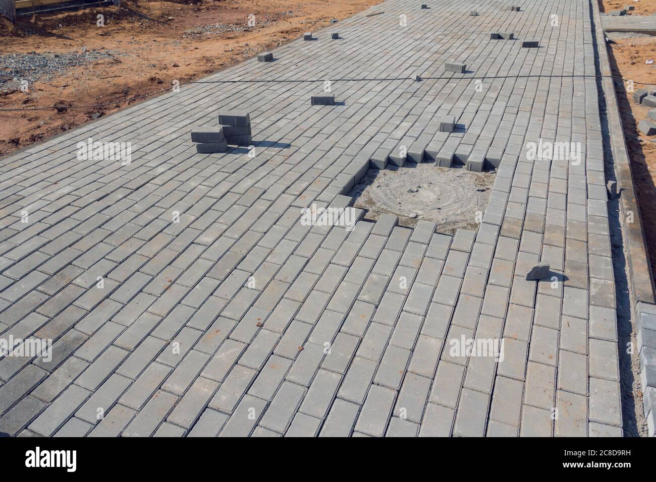 Construction of pavement near the house. Bricklayer places concrete ...