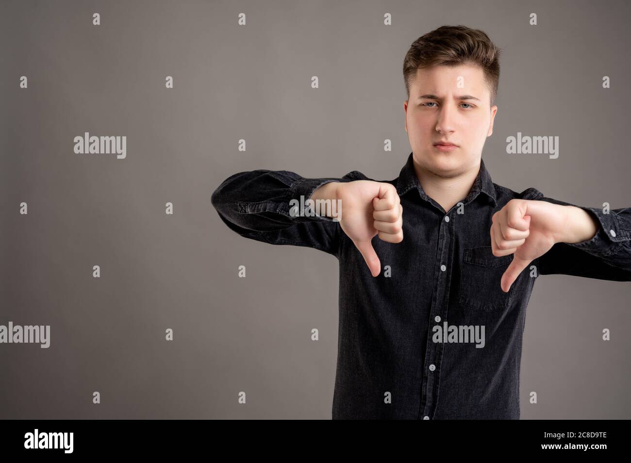 Portrait of serious stylish attractive man dressed with a casual black ...