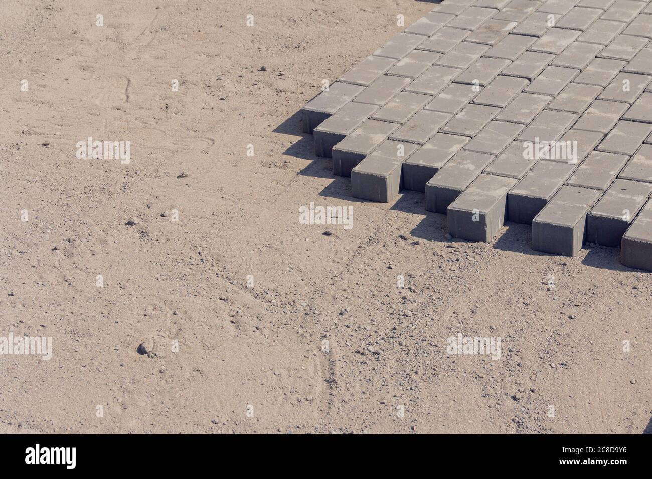 Construction of pavement near the house. Bricklayer places concrete ...