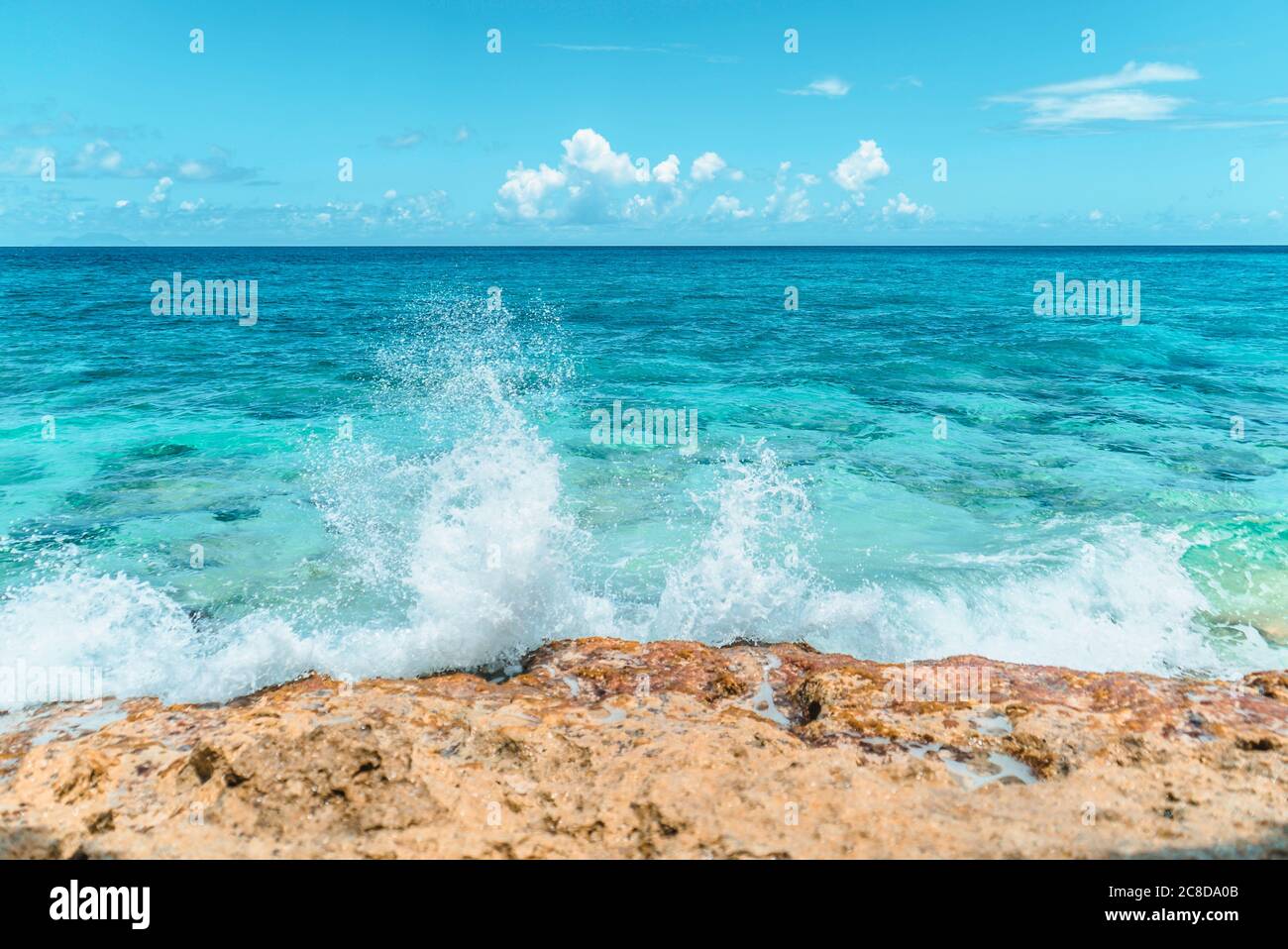 Blue sea water clashing on beautiful beach coast Stock Photo - Alamy