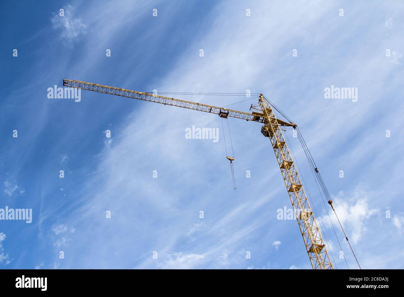Tower crane. Construction machinery against a blue sky with clouds ...