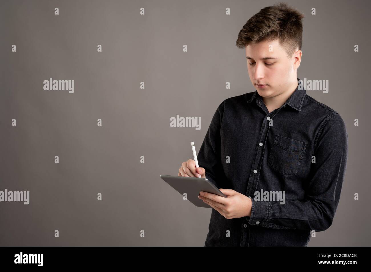 Portrait of serious stylish attractive man dressed with a casual black ...