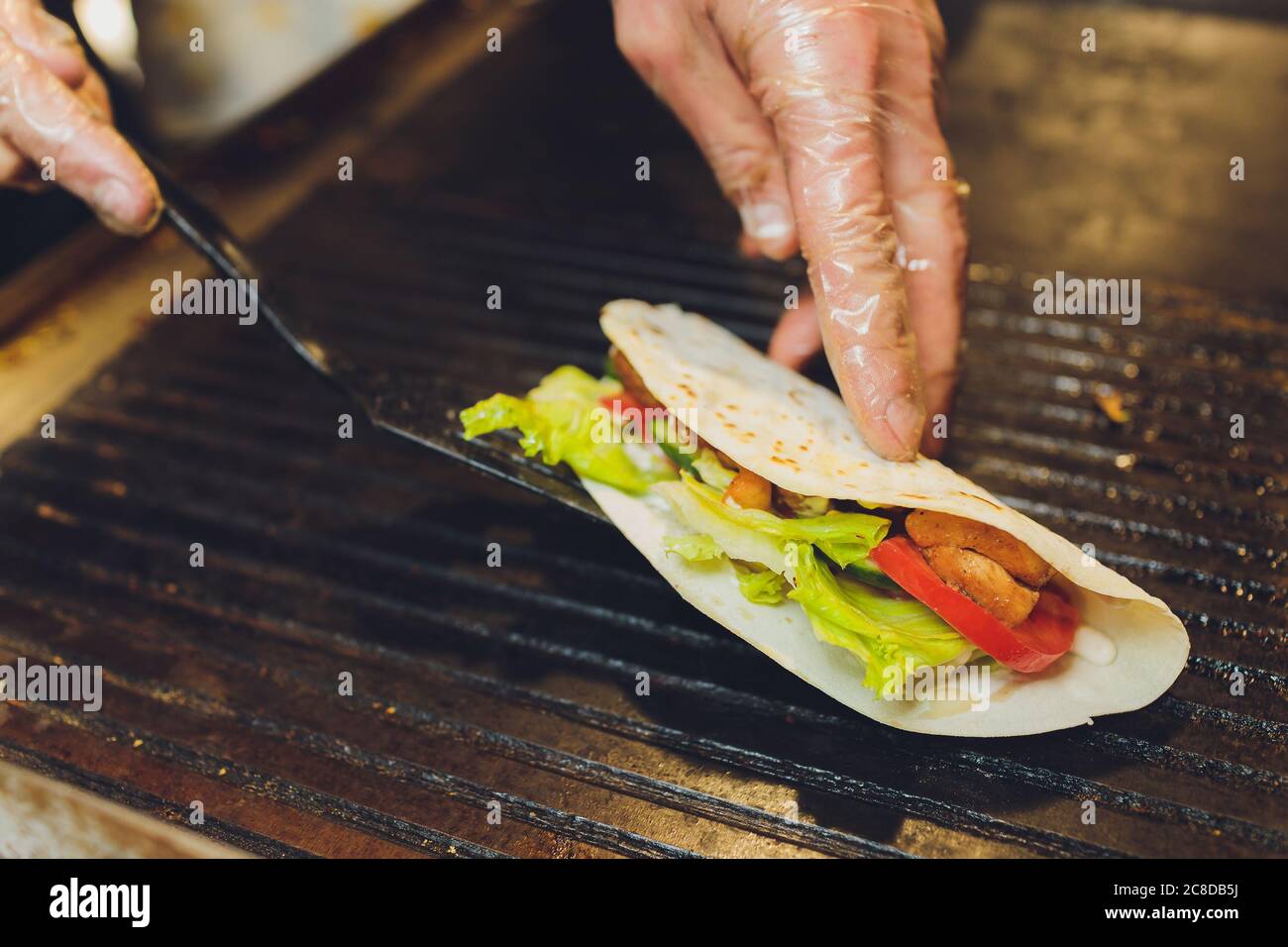 Chef making tacos at a street cafe. selective focus Stock Photo - Alamy