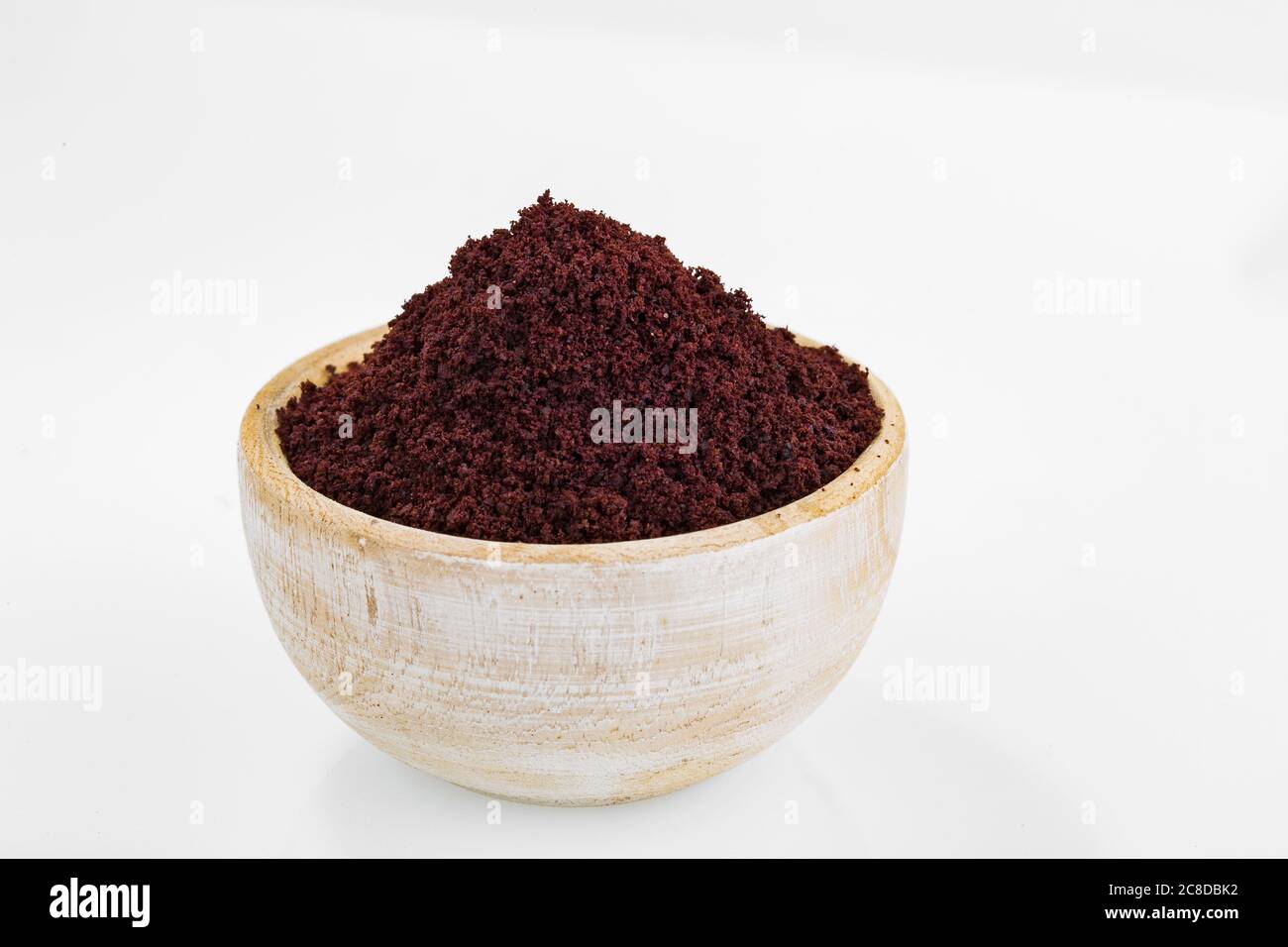 Açai powder in wooden bowl on white background, Euterpe oleracea Stock ...