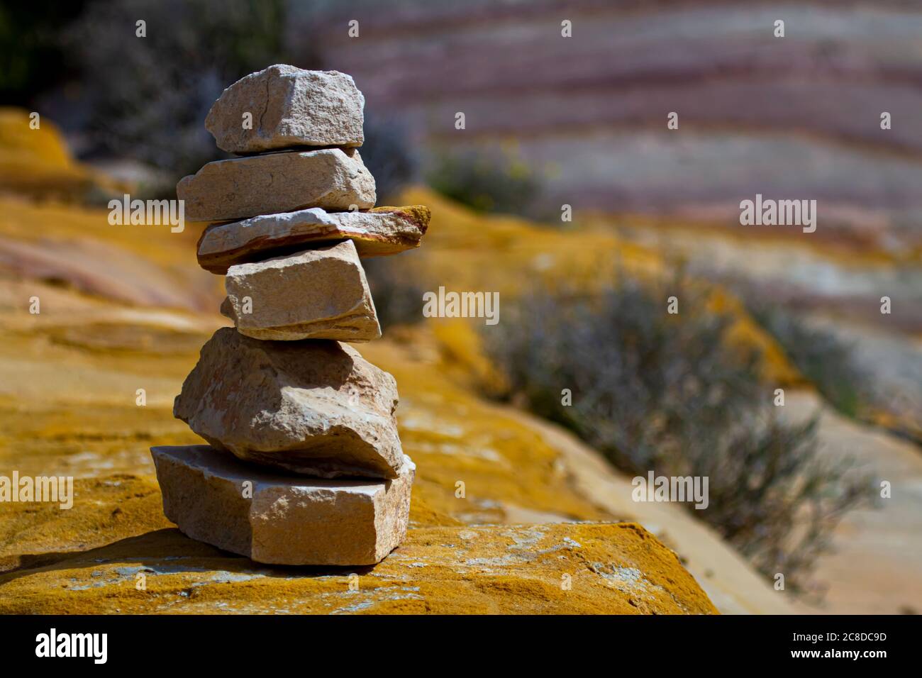 An abstract image of stones stacked up in a tower shape. Stones are ...