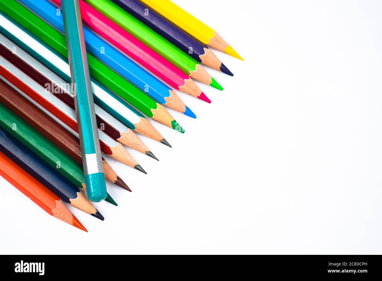 Light blue color wood pencil crayon placed on top of a row of different ...