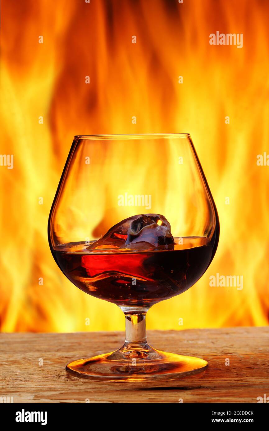 glass of cognac in front of the fireplace Stock Photo - Alamy