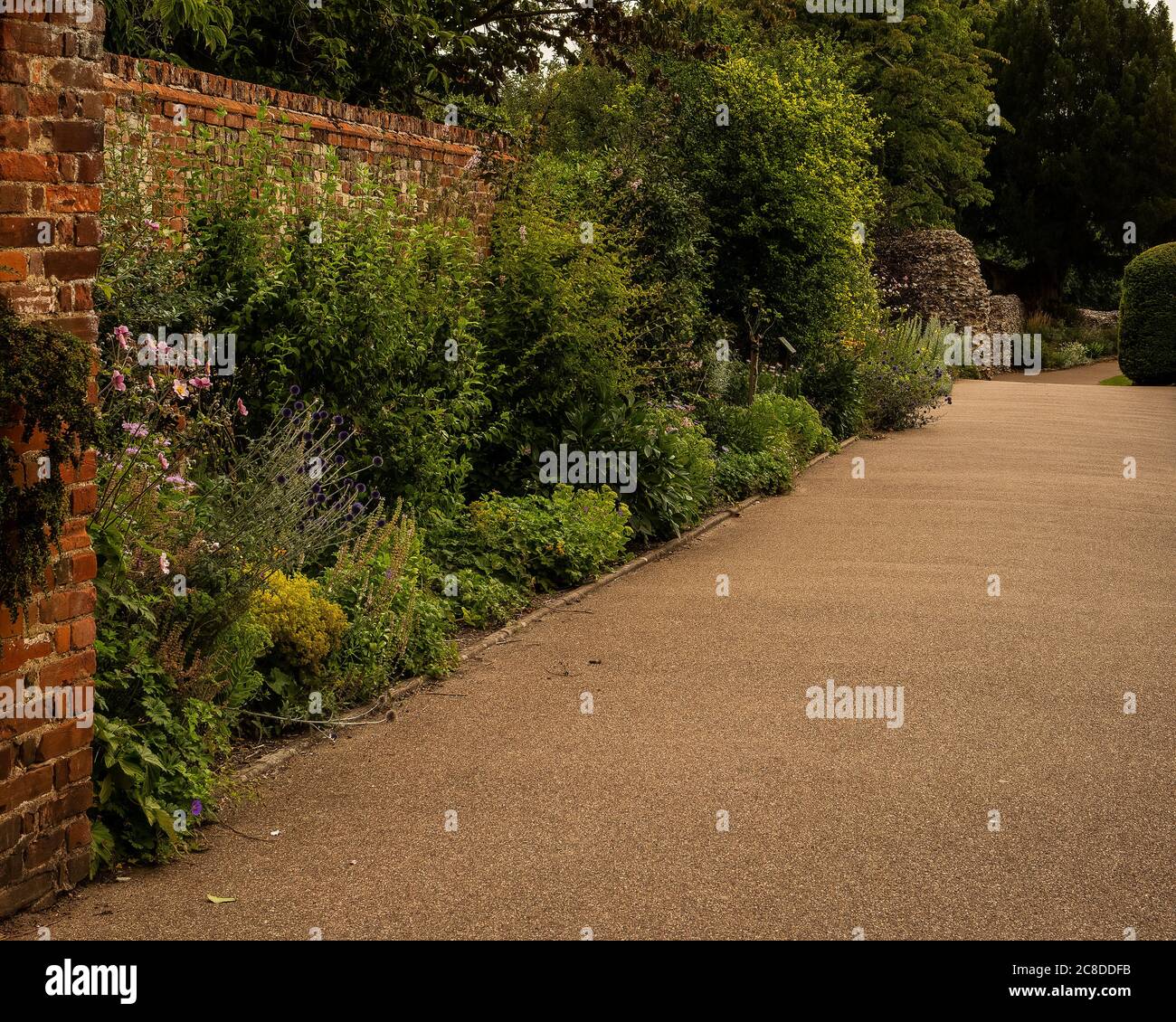 Long view of garden path with full flower bed on left and the wide ...