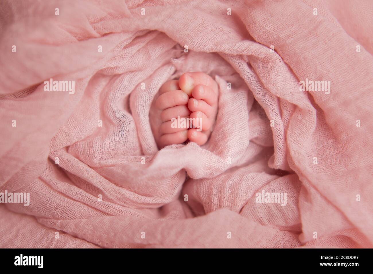 twisted child. Soft feet of a newborn Stock Photo - Alamy