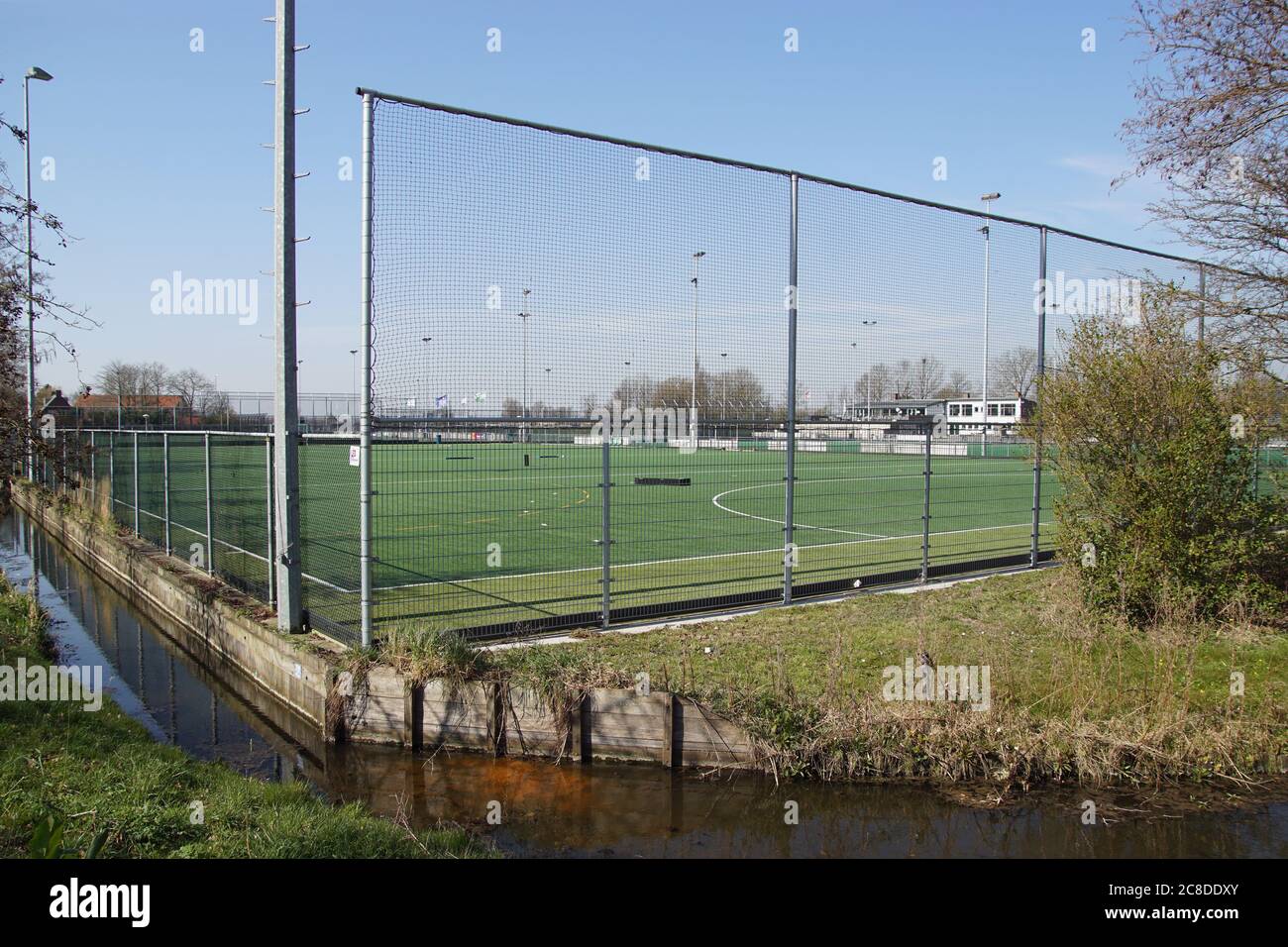 Field with artificial grass without an audience and hockey players from ...