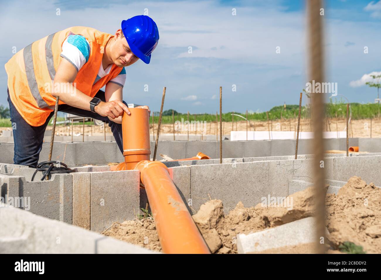 laying plastic pipes to the foundation of the building Stock Photo - Alamy