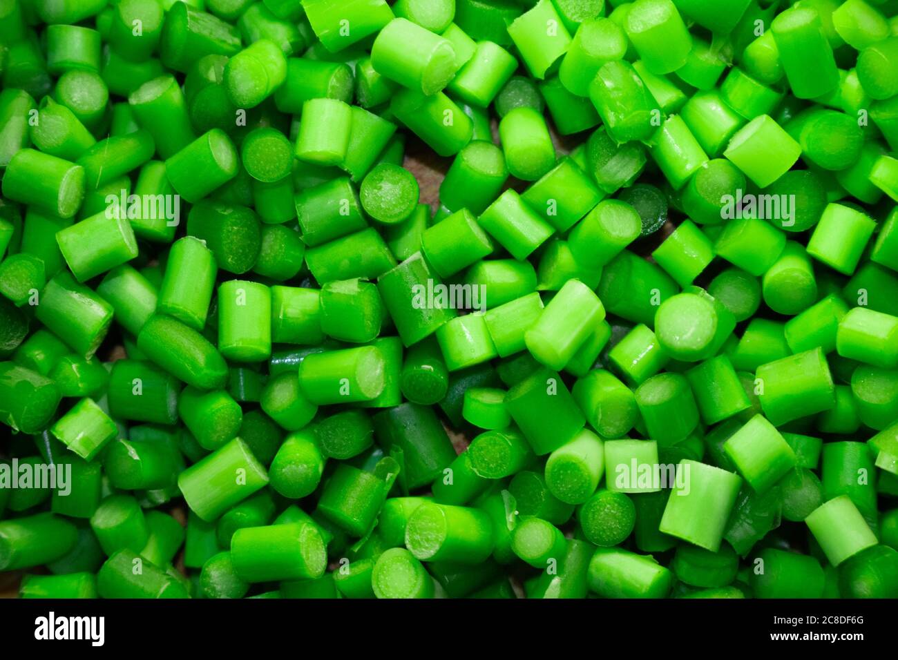 Cutting green garlic. Green background Stock Photo - Alamy
