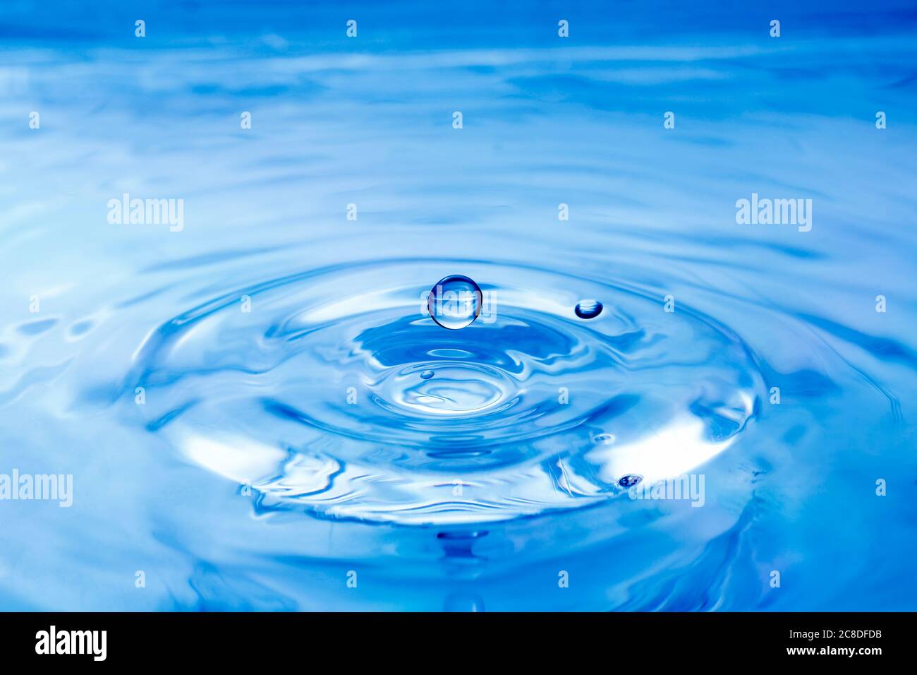 water drop over rippled water surface Stock Photo - Alamy
