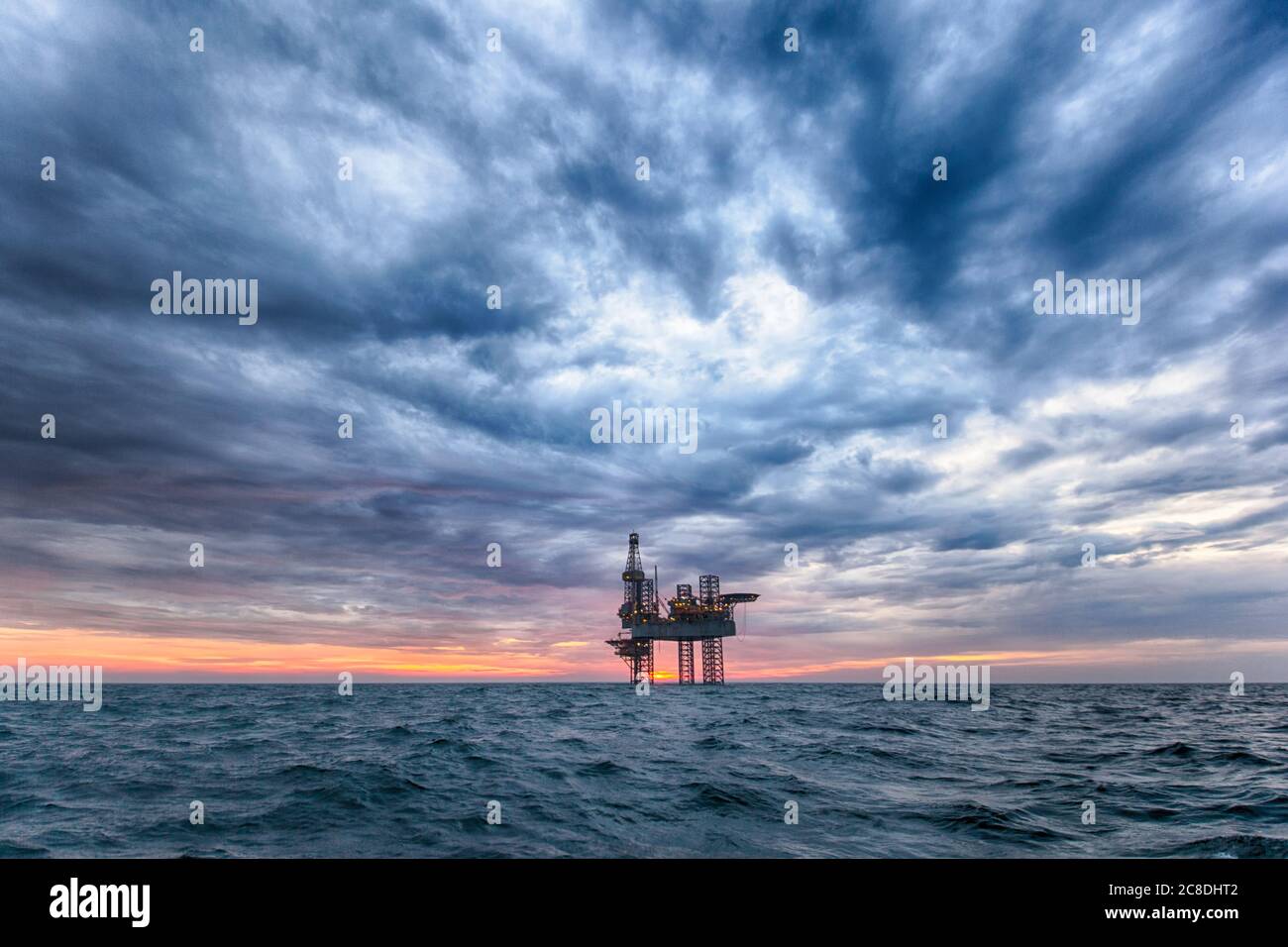 Oil rig at sunset time Stock Photo - Alamy