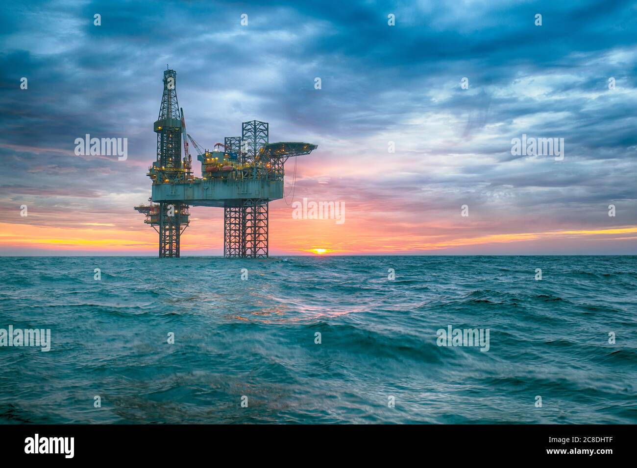 Oil rig at sunset time Stock Photo - Alamy