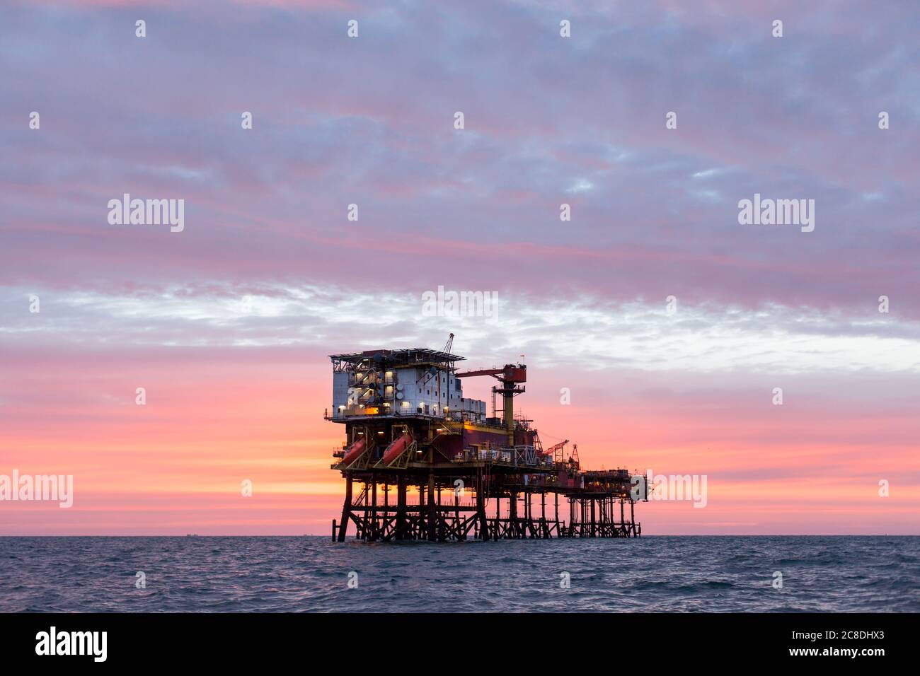 Offshore oil platform at sunset time Stock Photo - Alamy