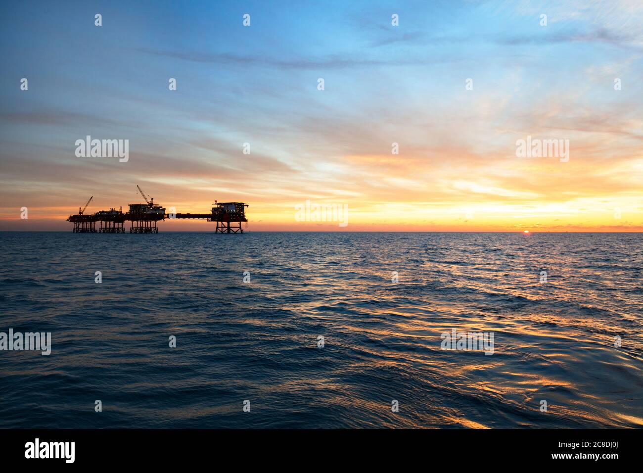 Offshore oil platform at sunset time Stock Photo - Alamy