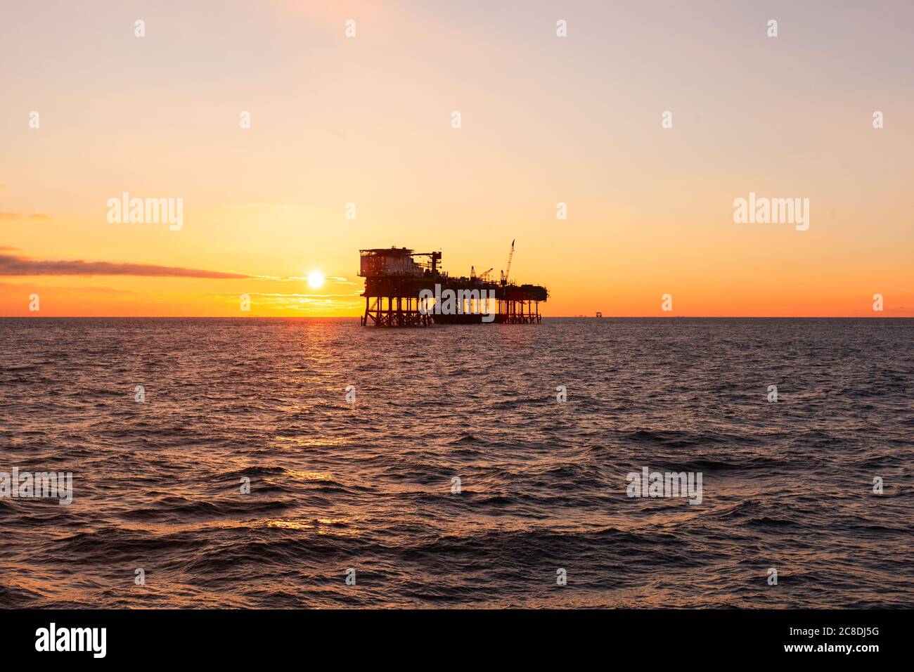 Offshore oil platform at sunset time Stock Photo - Alamy