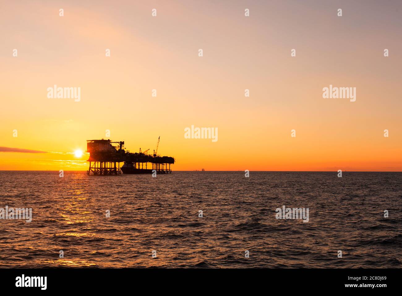 Offshore oil platform at sunset time Stock Photo - Alamy