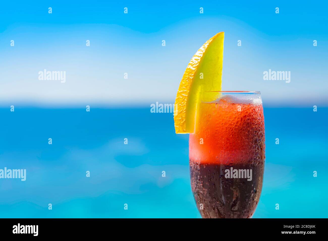 Refreshing juice cocktail with melon. Blue sea on the background ...
